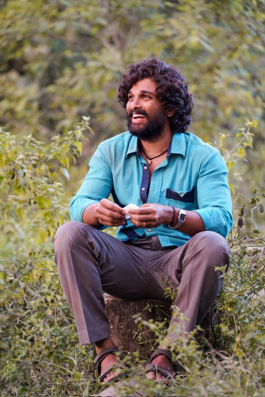 Allu Arjun as Pushpa Raj Smiling Outdoors Wallpaper | Background FREE ...