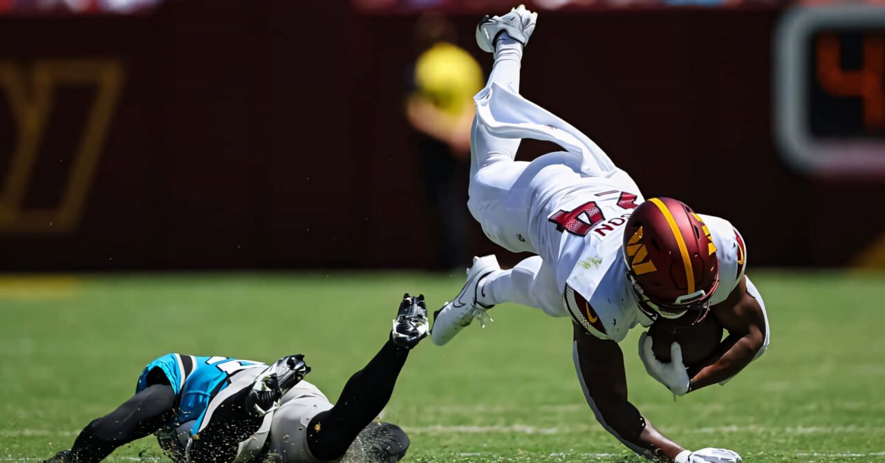 Antonio Gibson Mid-Air Tackle Football Action Wallpaper | Background ...