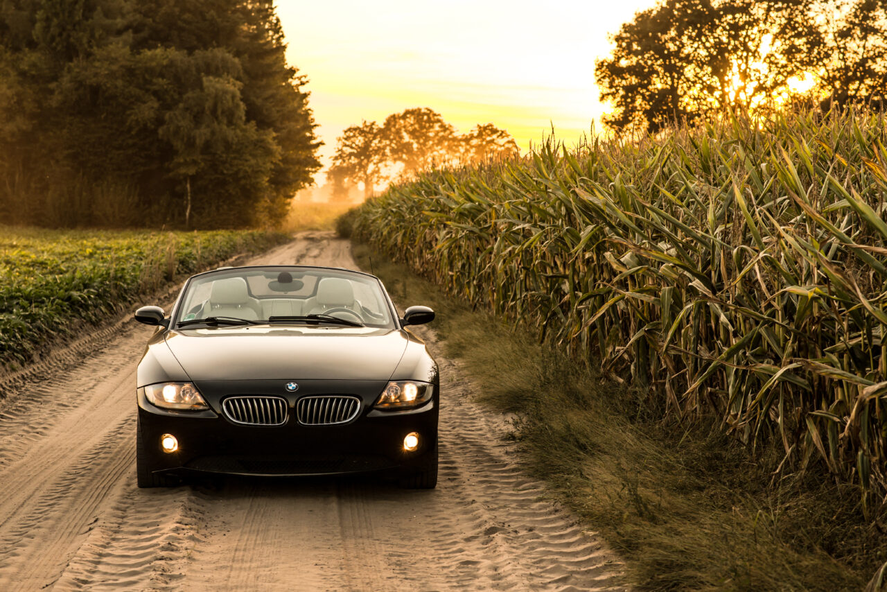Sleek BMW on Scenic Sunset Road Wallpaper | Background FREE Download ...