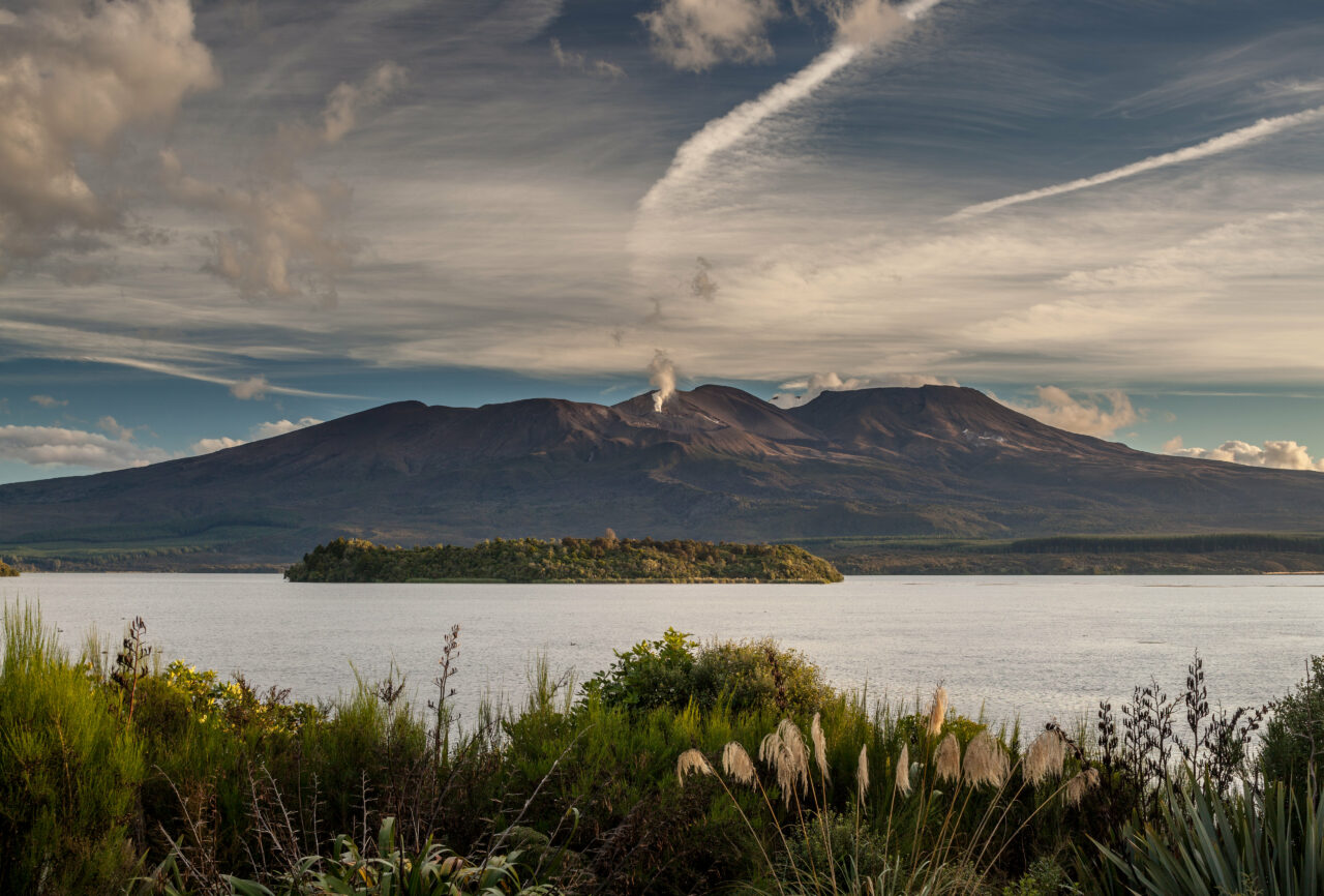 Smoking Volcano Over Rugged Mountains and Sea Wallpaper | Background ...