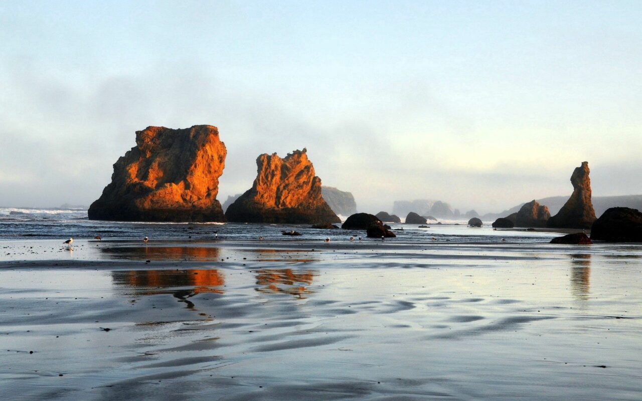 Golden Sunrise Over Rugged Sea Stacks Calm Water Wallpaper | Background ...
