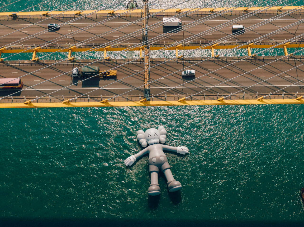 Floating KAWS Sculpture Under Bridge Modern Art Wallpaper | Background ...