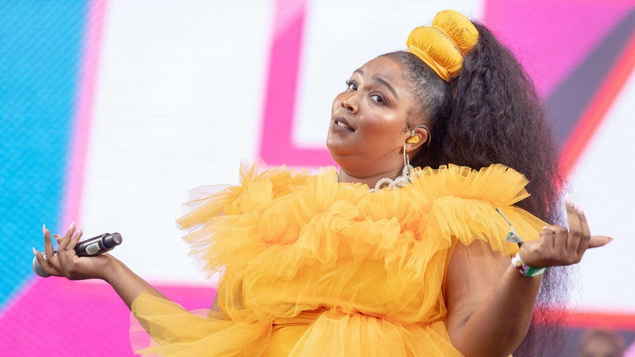 Charismatic Vibrance of Lizzo in Yellow Wallpaper | Background FREE ...