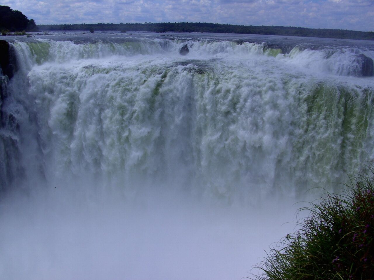 Majestic Waterfall Over Rocky Edge with Misty Spray Wallpaper ...