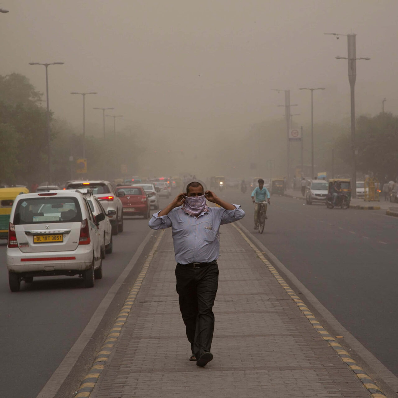 Man Shielding Face in Dust Storm Urban Street Wallpaper | Background ...