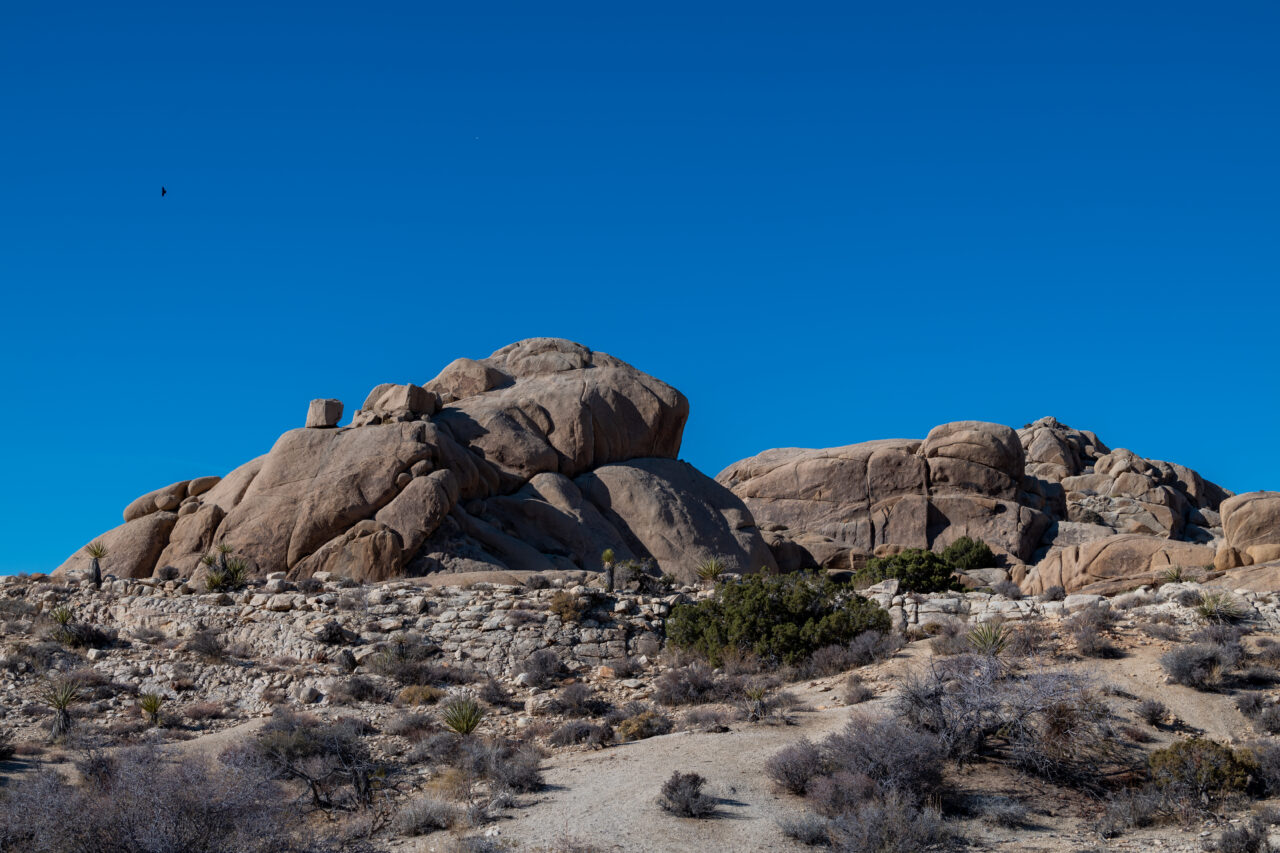 Massive Rocky Desert Landscape Under Blue Sky Wallpaper | Background ...
