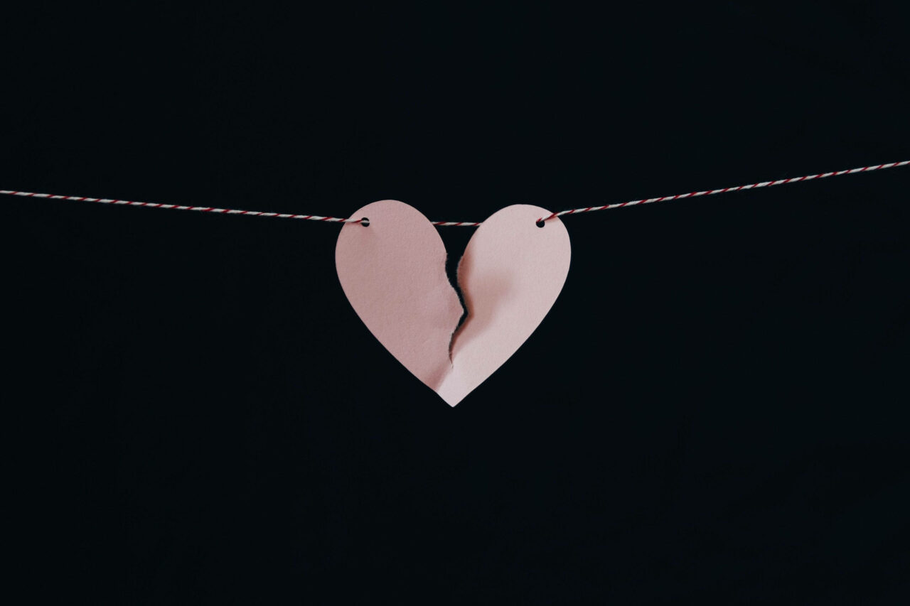 Minimalist Pink Broken Heart Hanging on Dark Background Wallpaper ...