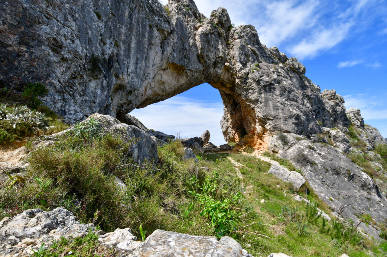 Natural Rock Arch and Greenery Under Blue Sky Wallpaper | Background ...