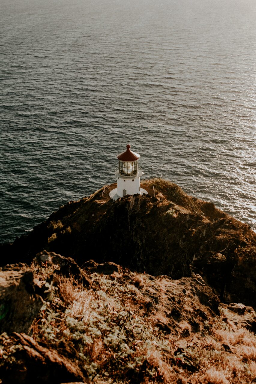 Serene Lighthouse on Cliff by Calm Sea Wallpaper | Background FREE ...
