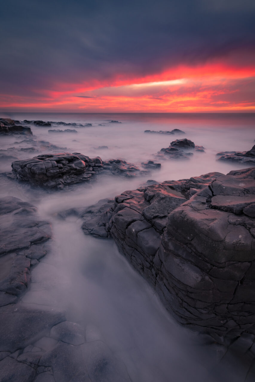 Sunset Coastal Stone Formations Serene Seascape Wallpaper | Background ...