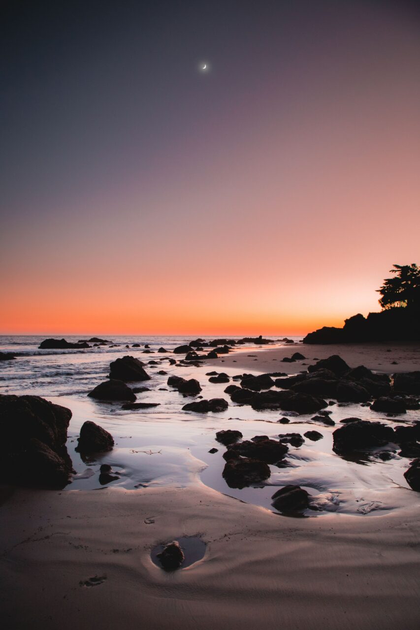 Tranquil Sunset Sea with Smooth Stones Coastal Wallpaper | Background ...