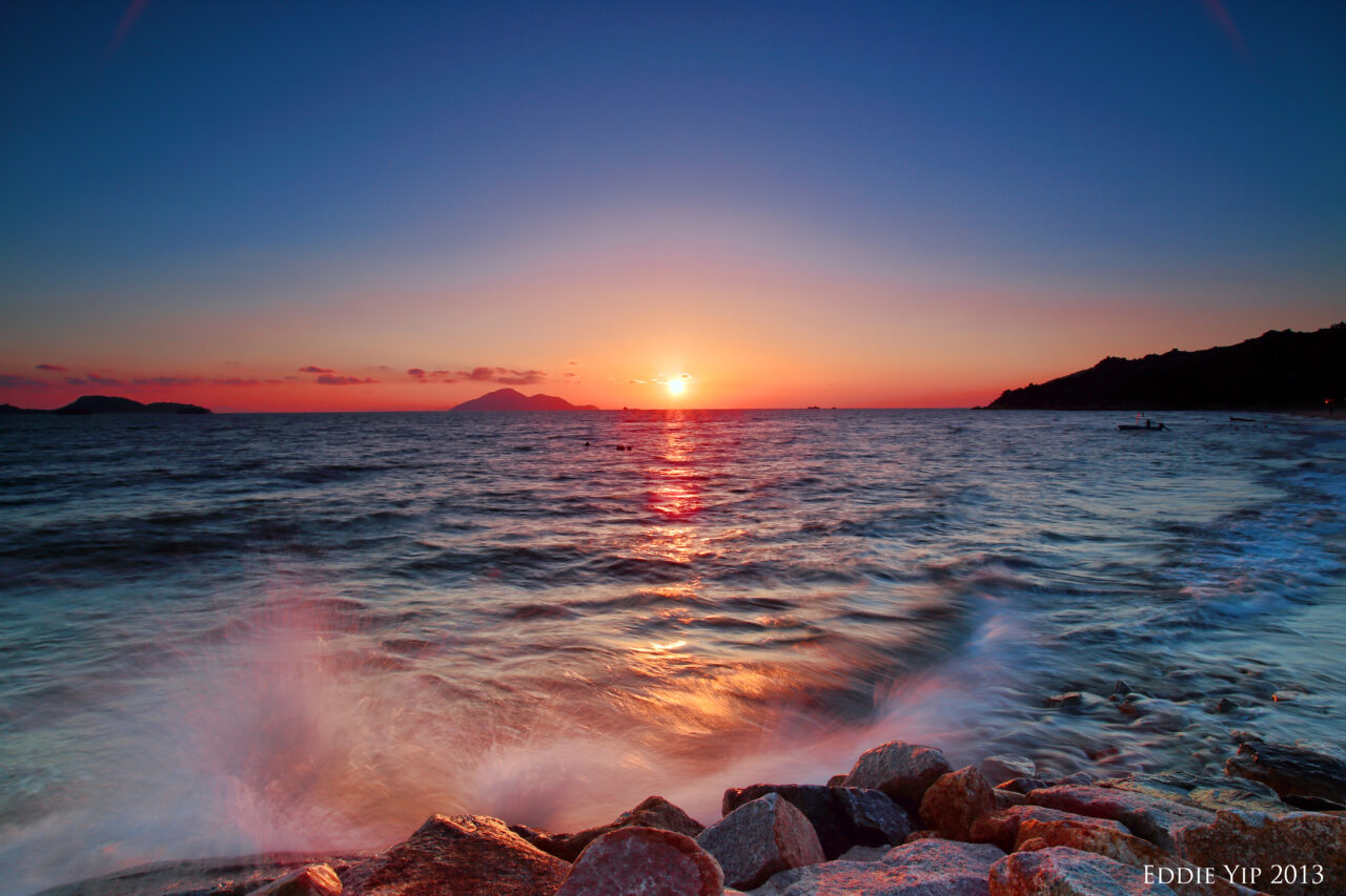 Vibrant Sunset Over Rocky Shoreline Peaceful Sea Wallpaper | Background ...