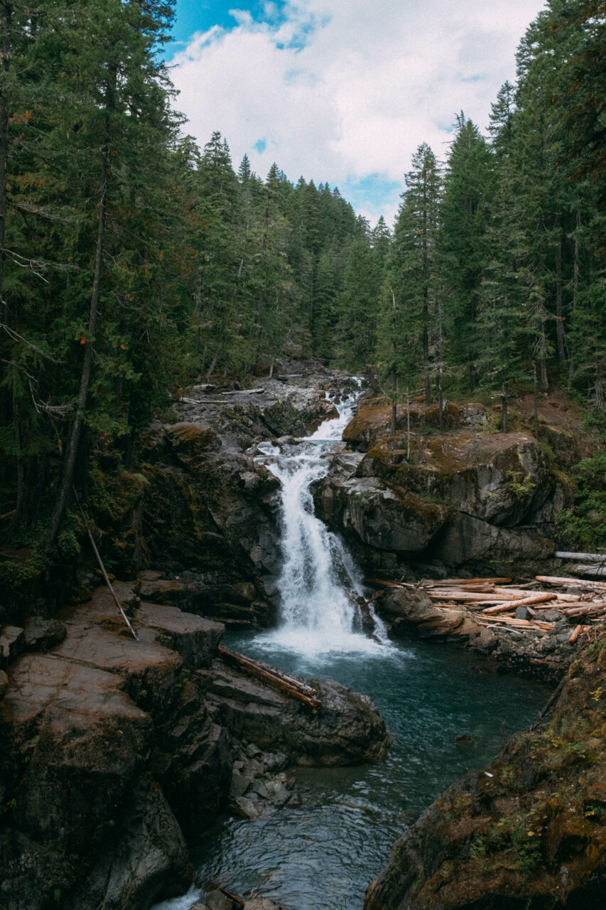 Tranquil Waterfall Over Rocks Forest Landscape Wallpaper | Background ...