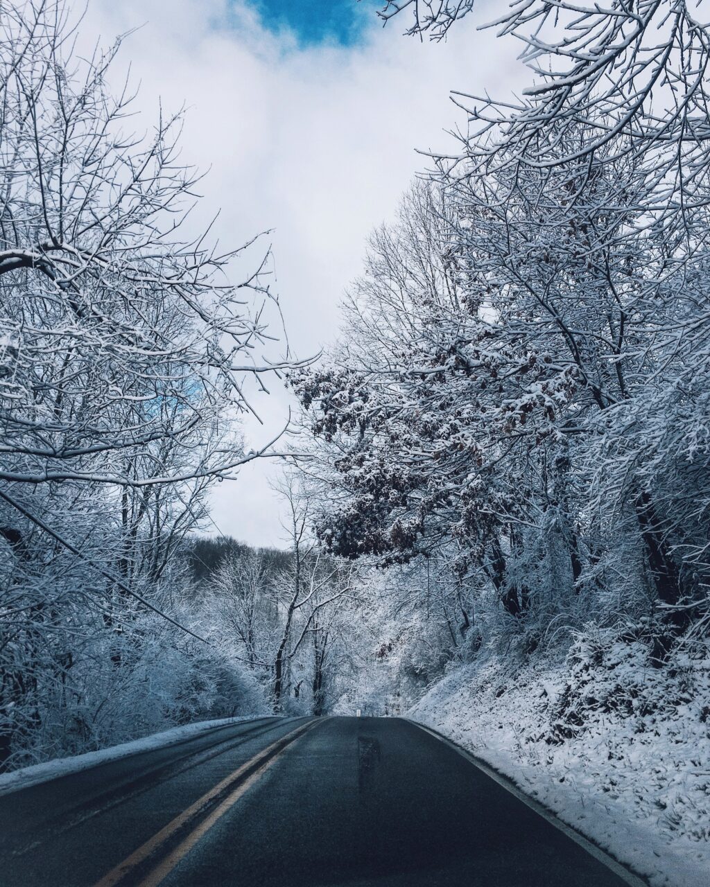Peaceful Snowy Road with Yellow Markings Winter Wallpaper | Background ...