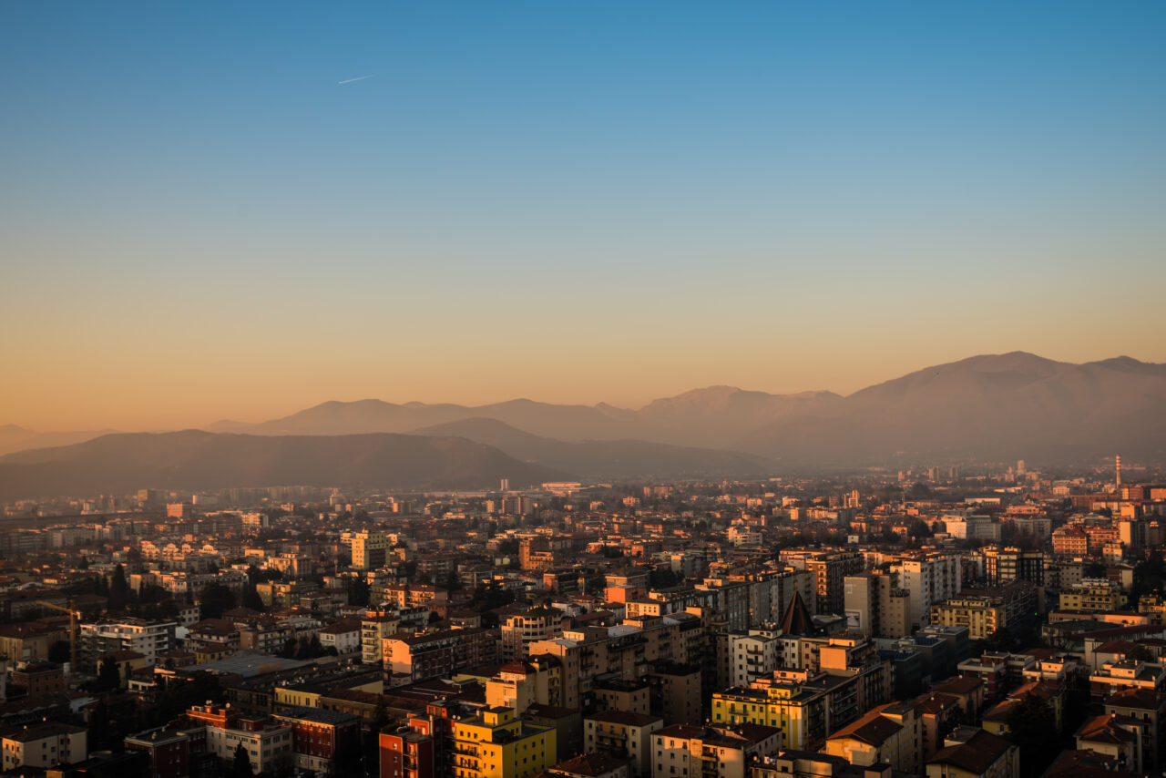 Sunset Cityscape with Majestic Mountains Wallpaper | Background FREE ...