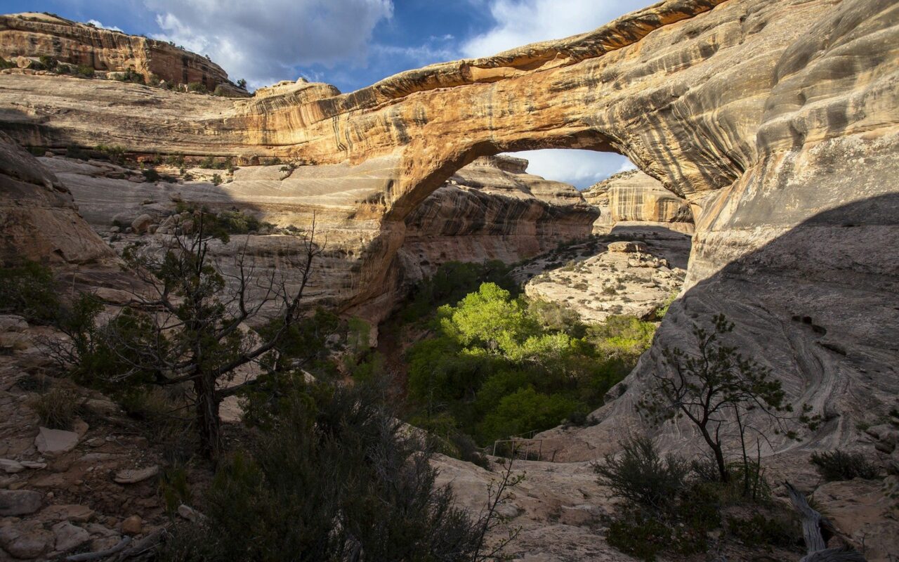 Sunlit Natural Stone Arch in Rugged Mountains Wallpaper | Background ...