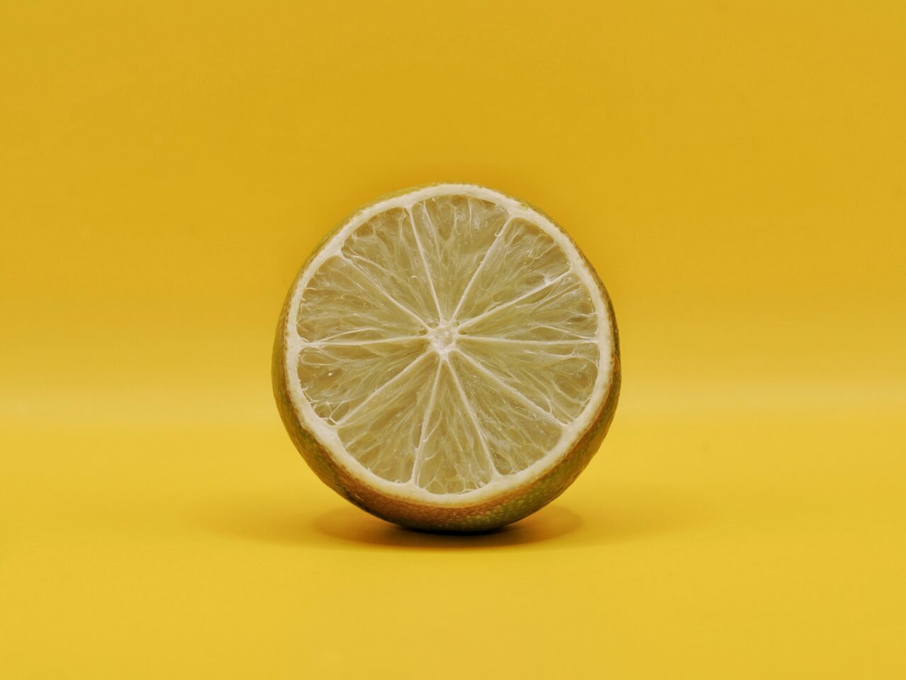 Zesty Lemon Slice on Bright Yellow Wallpaper | Background FREE Download ...