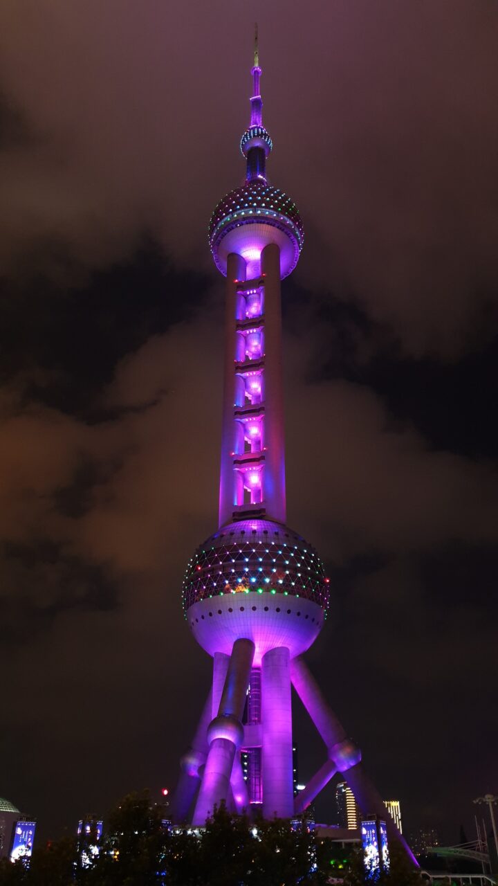 Vibrant Purple Tower Against Dramatic Clouds Wallpaper | Background ...